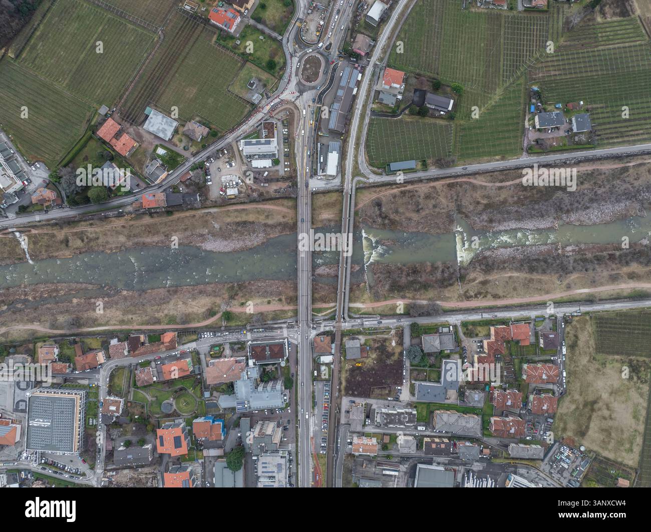 Aerial view of Lavis, Trento with Avisio river, creek, road, and ...