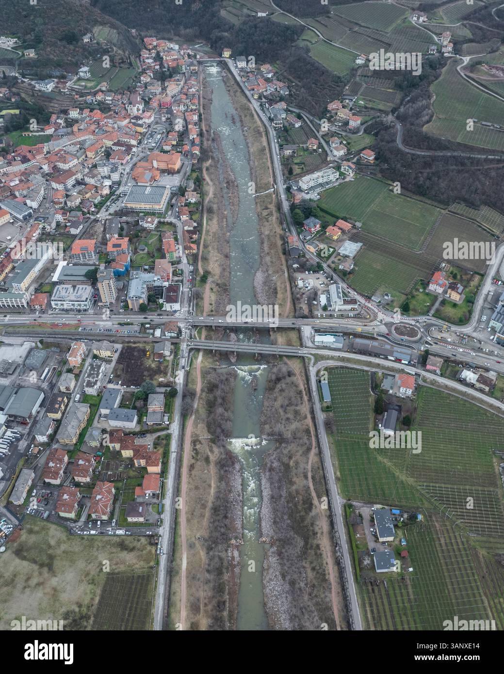 Aerial view of Lavis, Trento with Avisio river, creek, road, and ...
