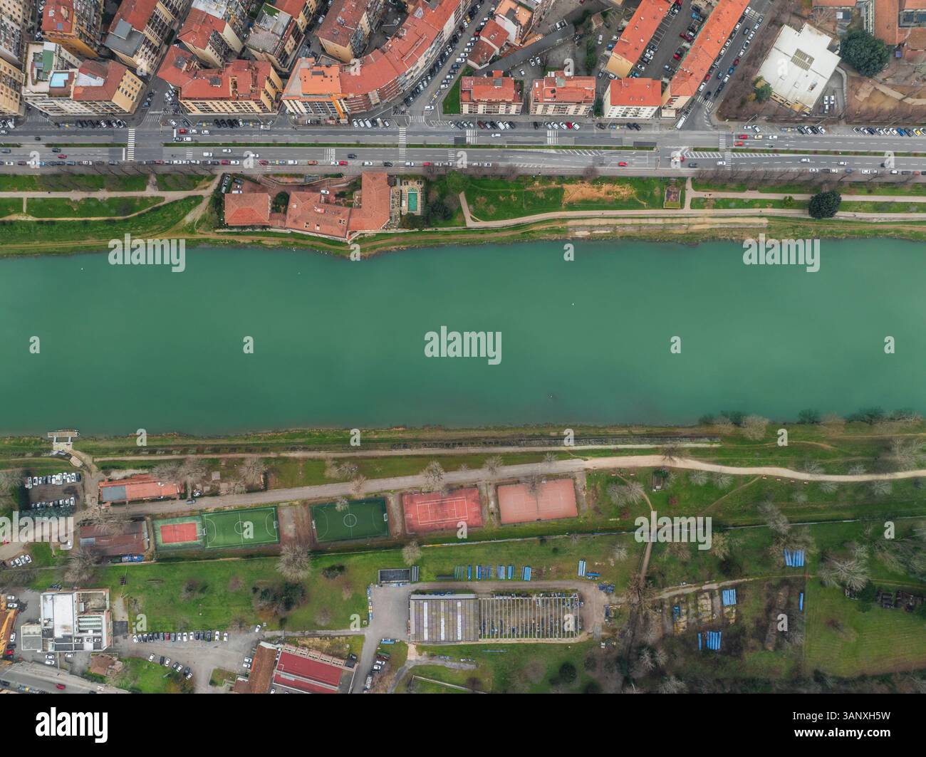 Aerial view of a public park with sport fields along the Arno river ...