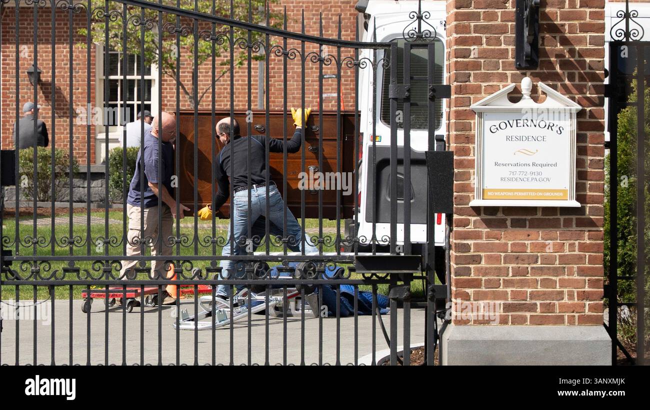 Workers move furniture following an arson attack on the Pennsylvania ...
