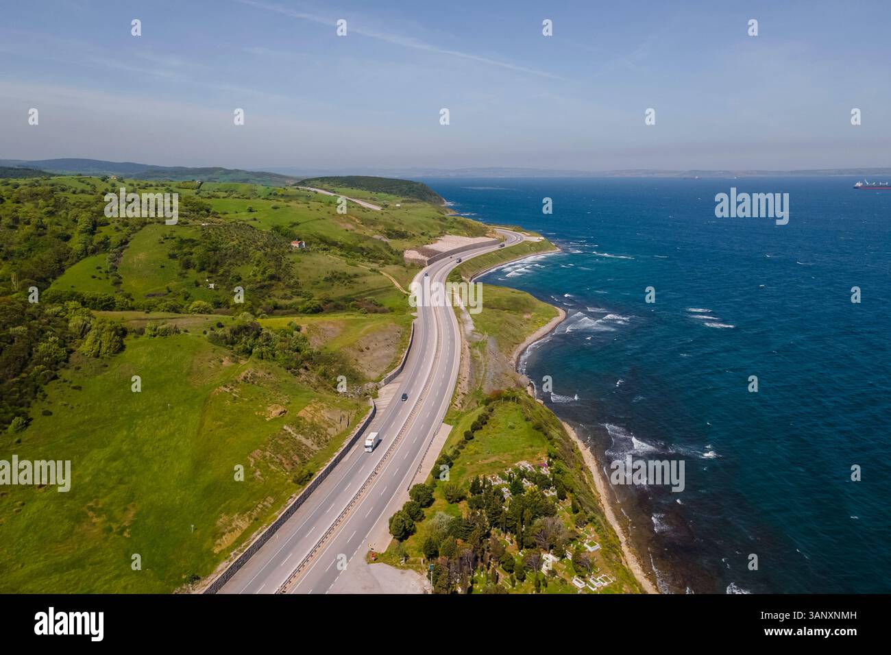 Aerial view of a serpentine road following the coastline along the ...