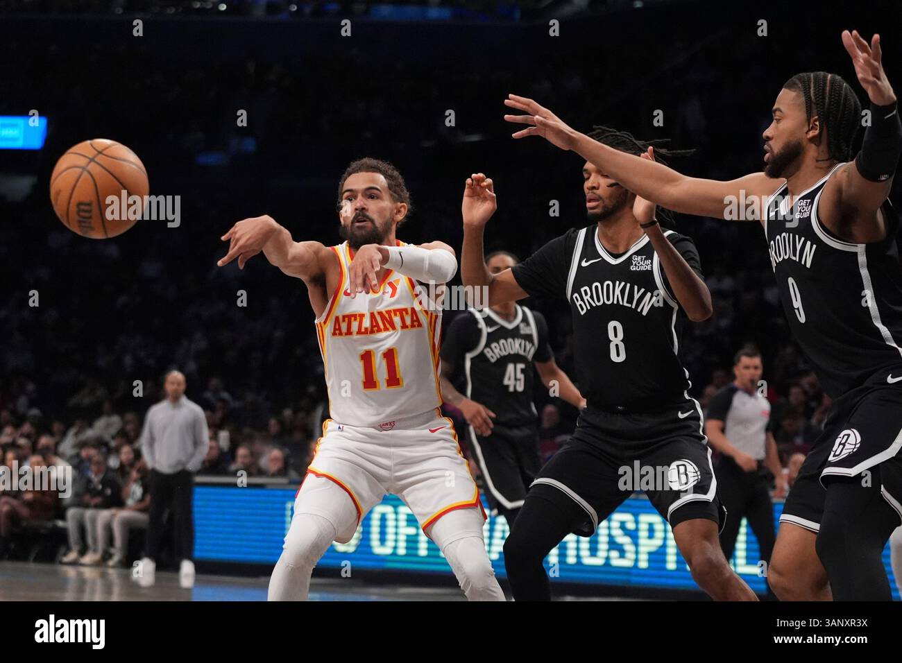 Atlanta Hawks' Trae Young (11) passes away from Brooklyn Nets' Ziaire ...