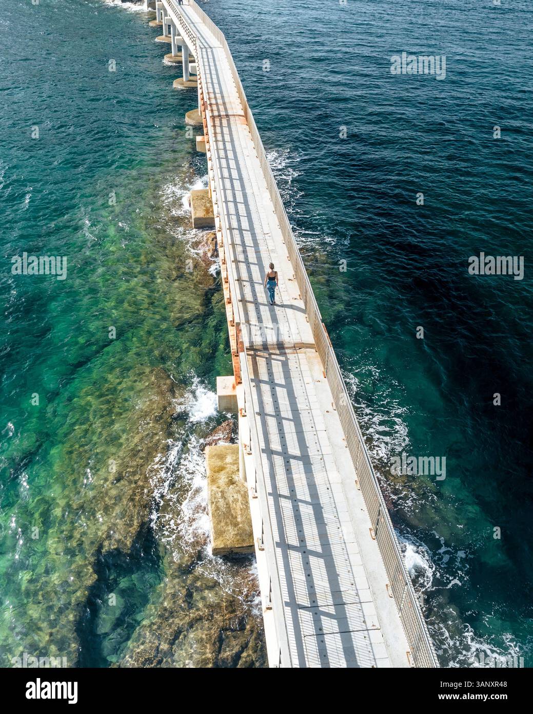 Aerial view of a woman walking on Vivara bridge connecting Vivara ...