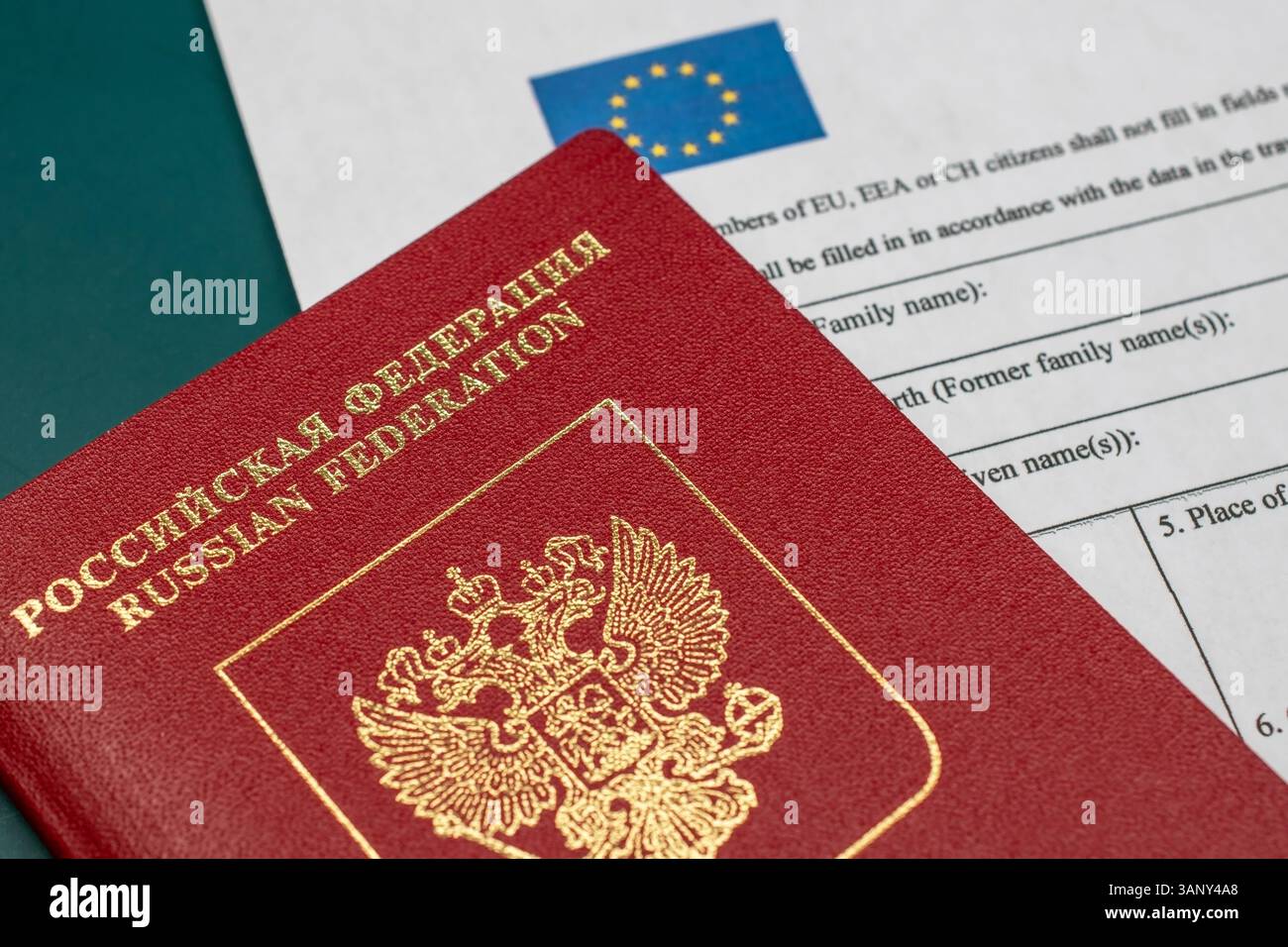 Russian passport document on top of Schengen visa form, emigration and ...