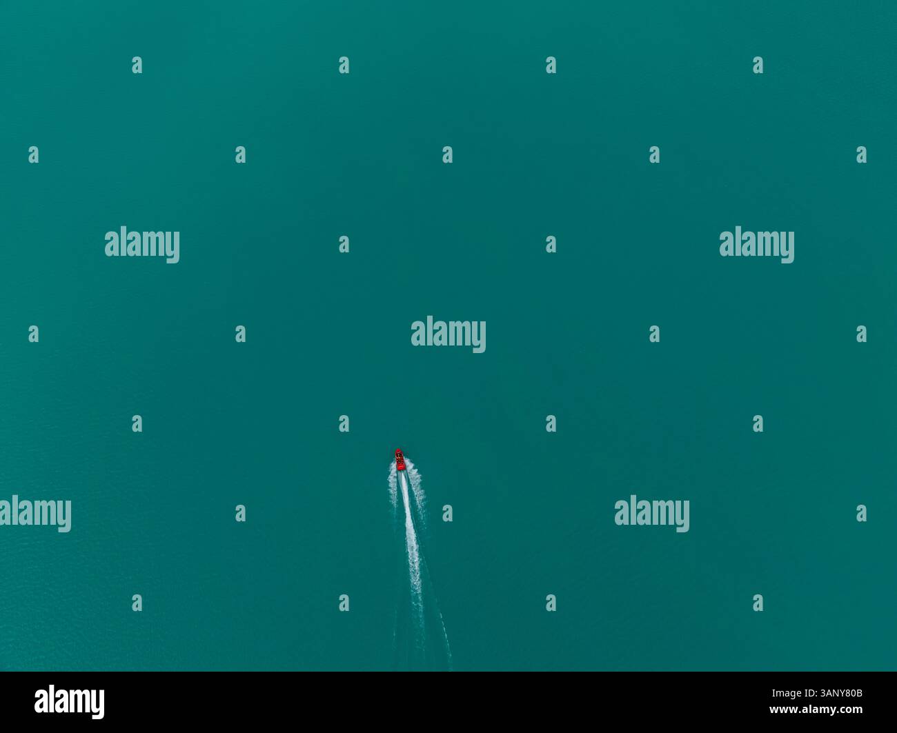 Aerial view of a boat sailing across the Brienzersee Lake in summertime ...
