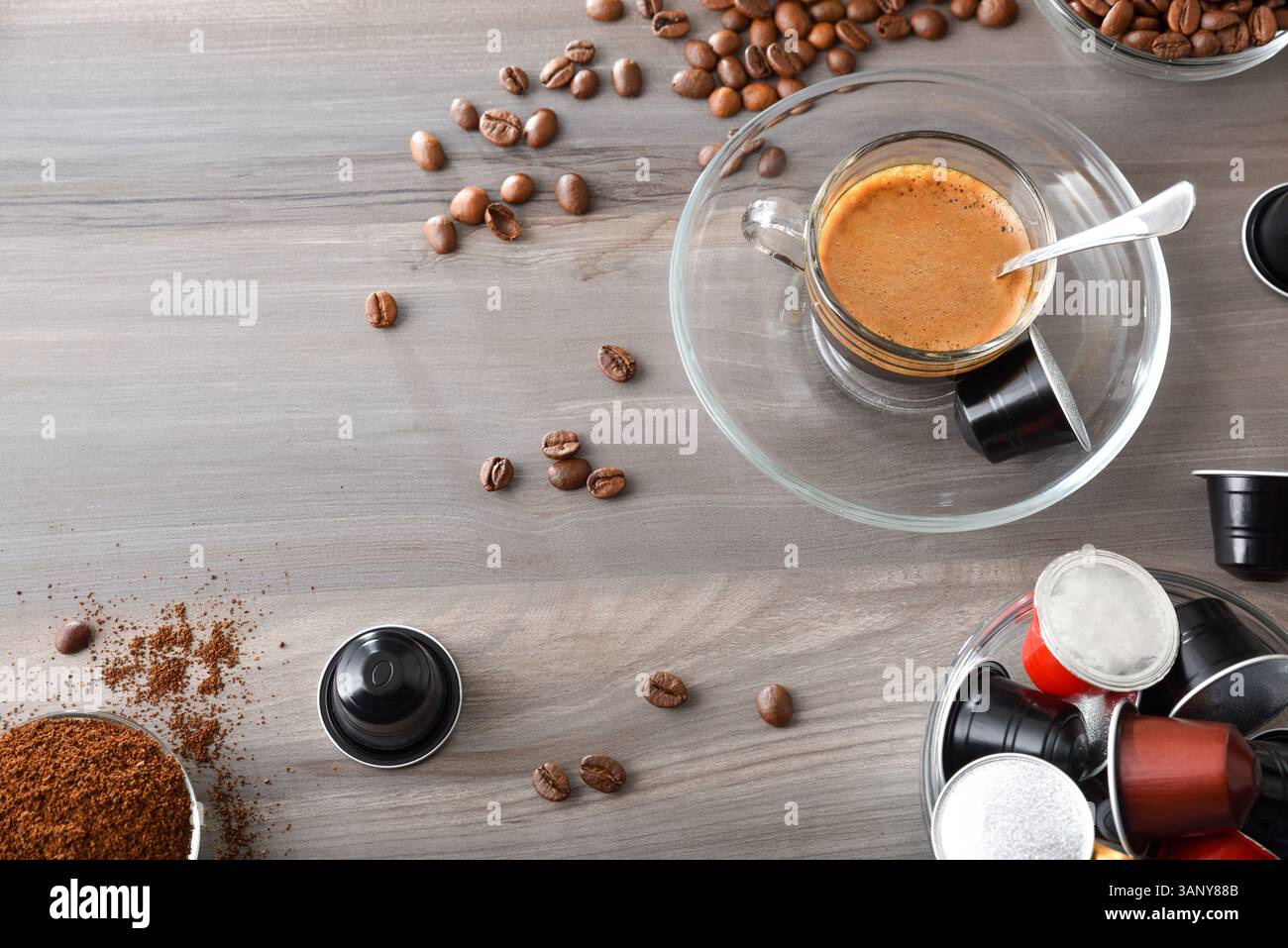 Espresso coffee in a glass cup on a wooden bench in a kitchen with ...