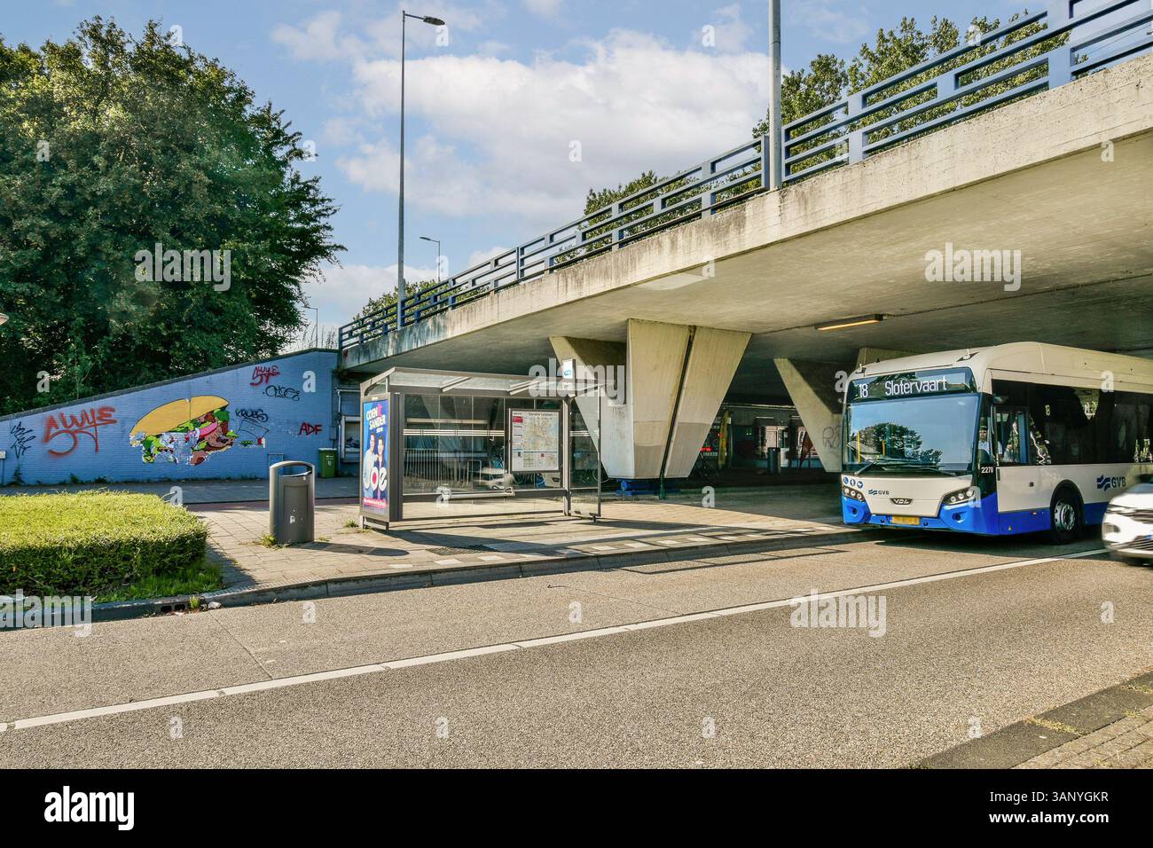 A modern bus stop in an urban environment with vibrant street art on ...