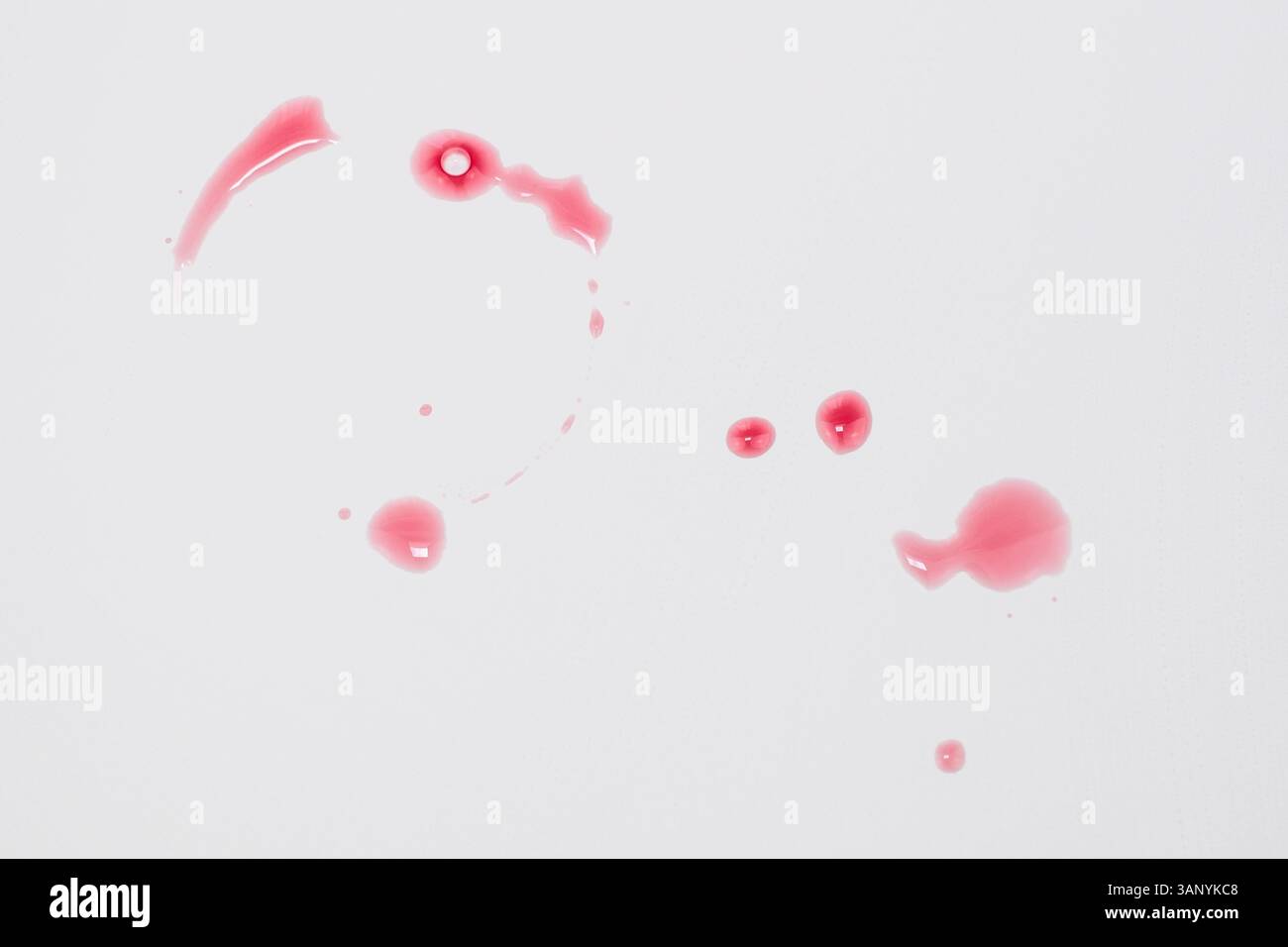 Flat lay wine splash on plain white background, top down shot of red ...