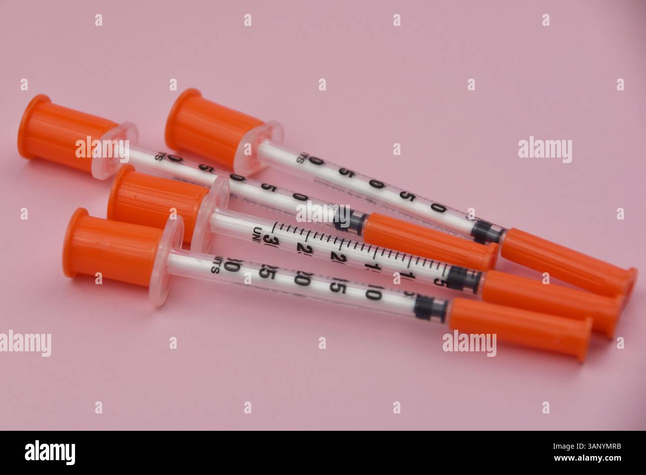 Plastic syringes for injection on a pink background close-up Stock ...