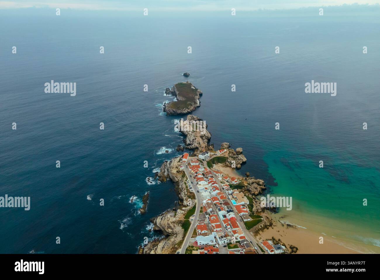 Aerial view of Ilha do Baleal, a small town on island at sunset along ...