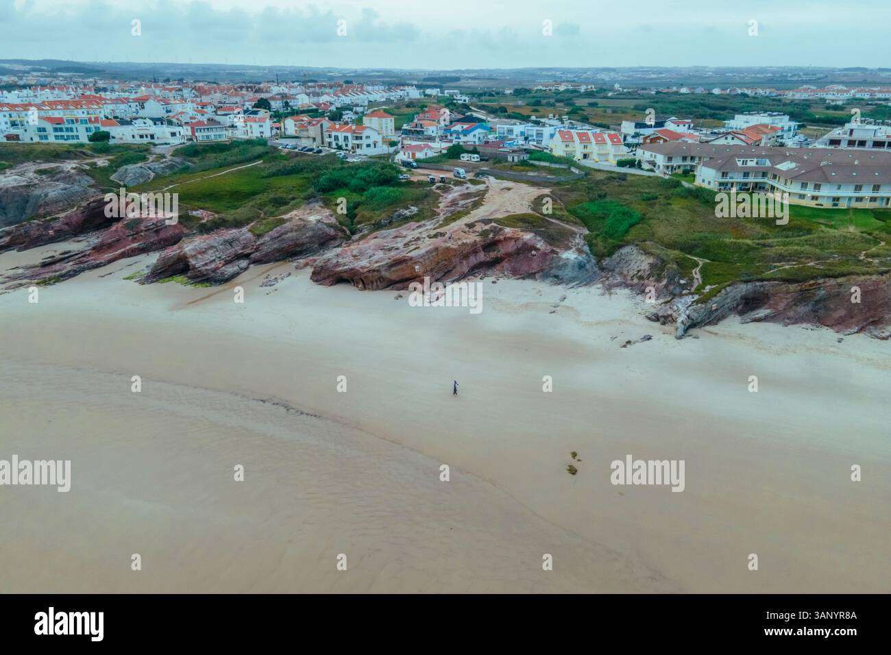 Aerial view of people on Praia Baleal an endless beach along the ocean ...