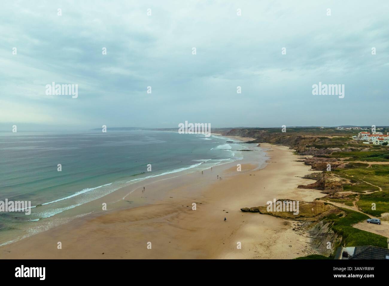 Aerial view of people on Praia Baleal, an endless beach along the ocean ...