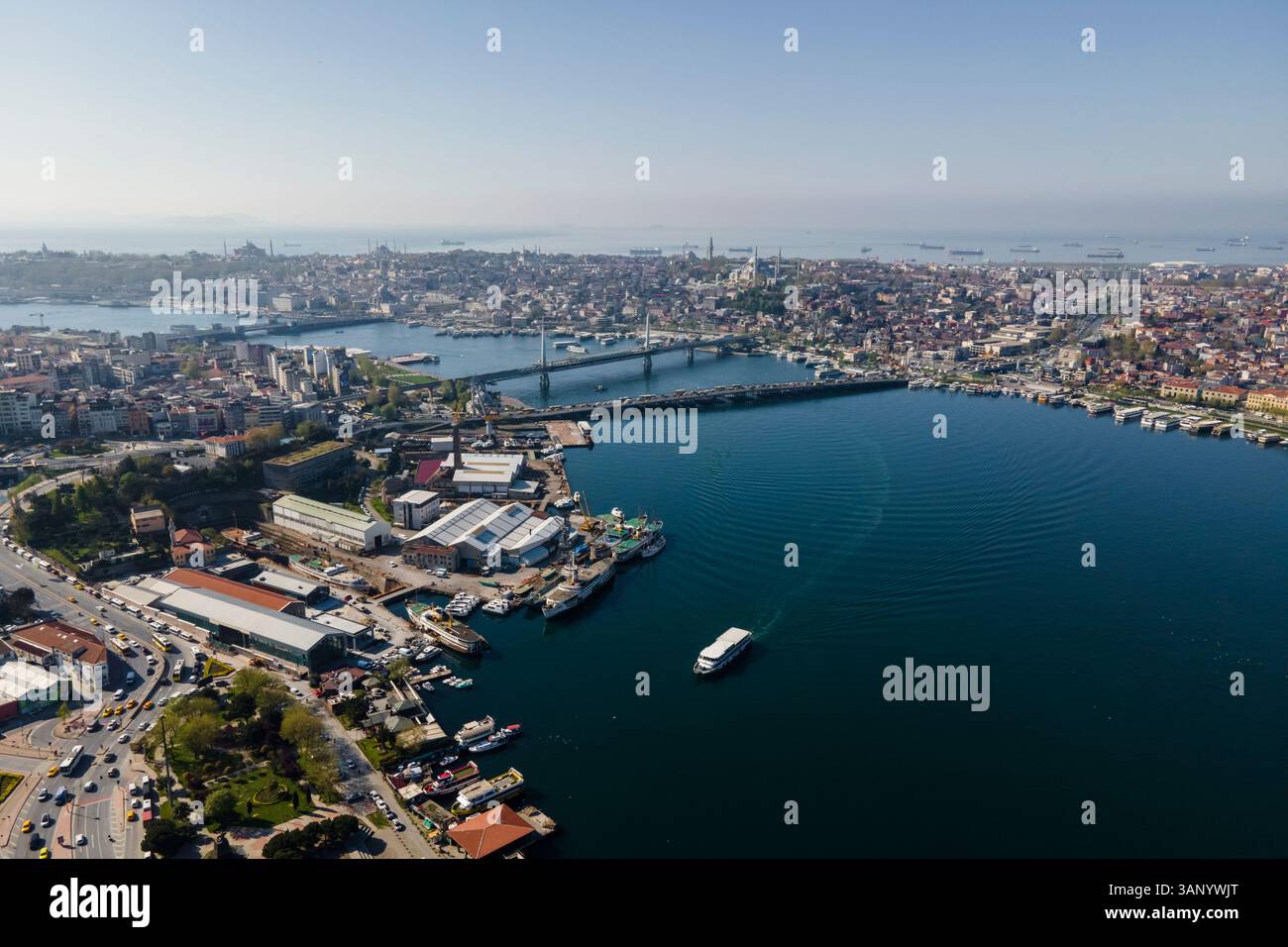 Aerial view of a boat sailing along the Golden Horn river estuary near ...