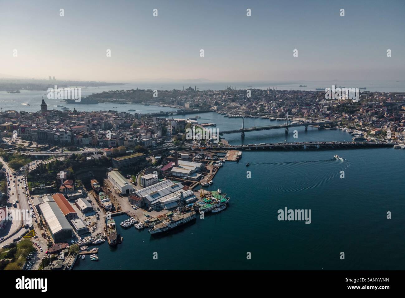 Aerial view of a boat sailing the Golden Horn waterway with Ataturk ...
