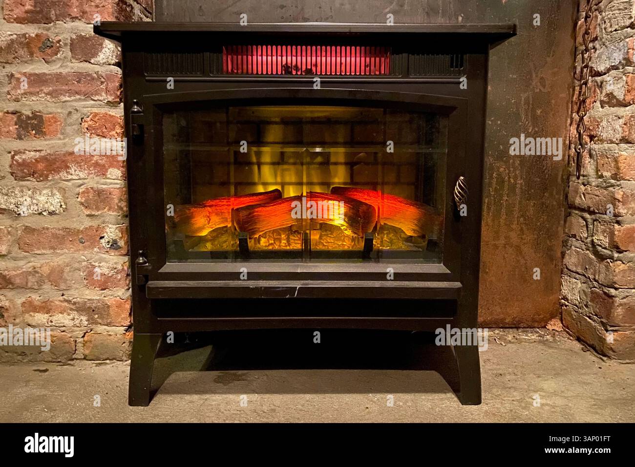 Burning fireplace against a brick wall Stock Photo - Alamy