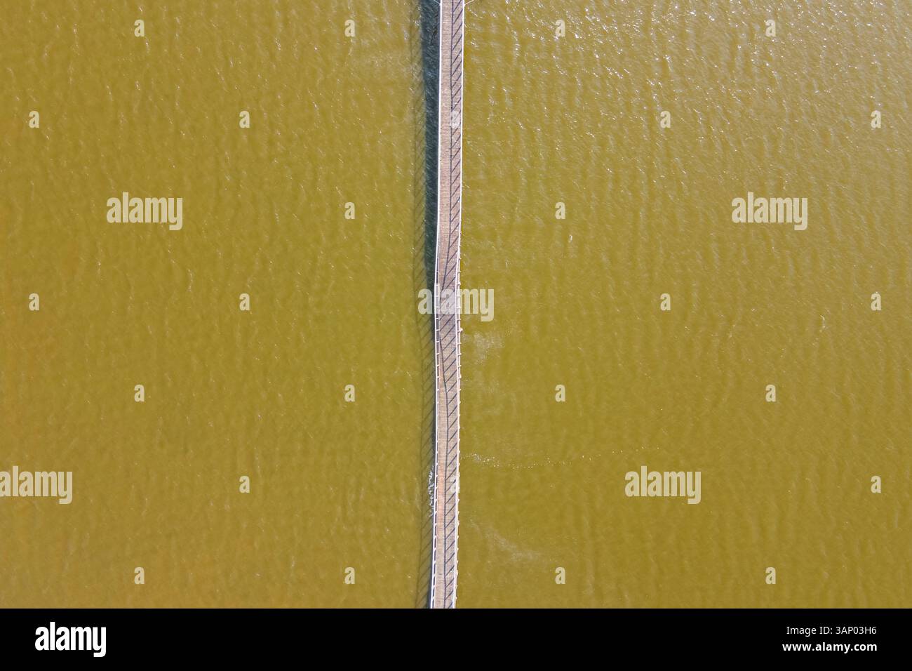 Aerial view of a long pier along Lesina Lake on Gargano natural park ...