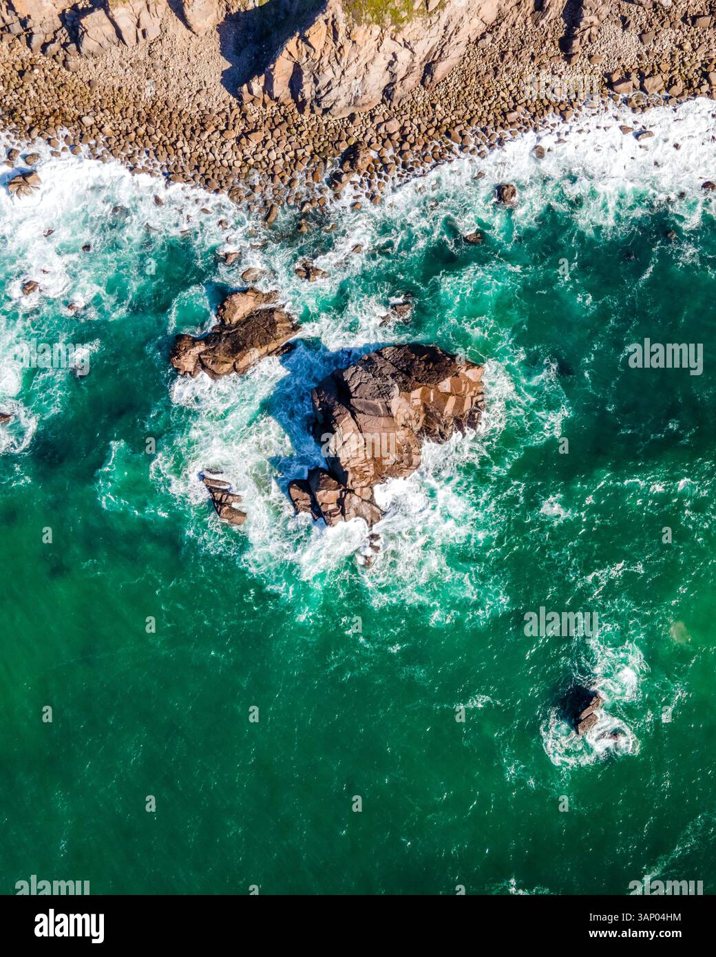 Aerial view of crispy waves rolling over the rocky promontory near Cabo ...