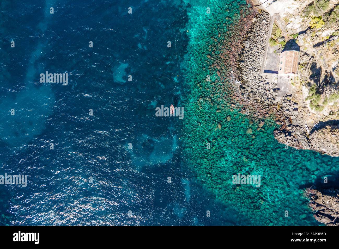 Aerial view of a fishing boat along the coast in Aci Trezza, Sicily ...