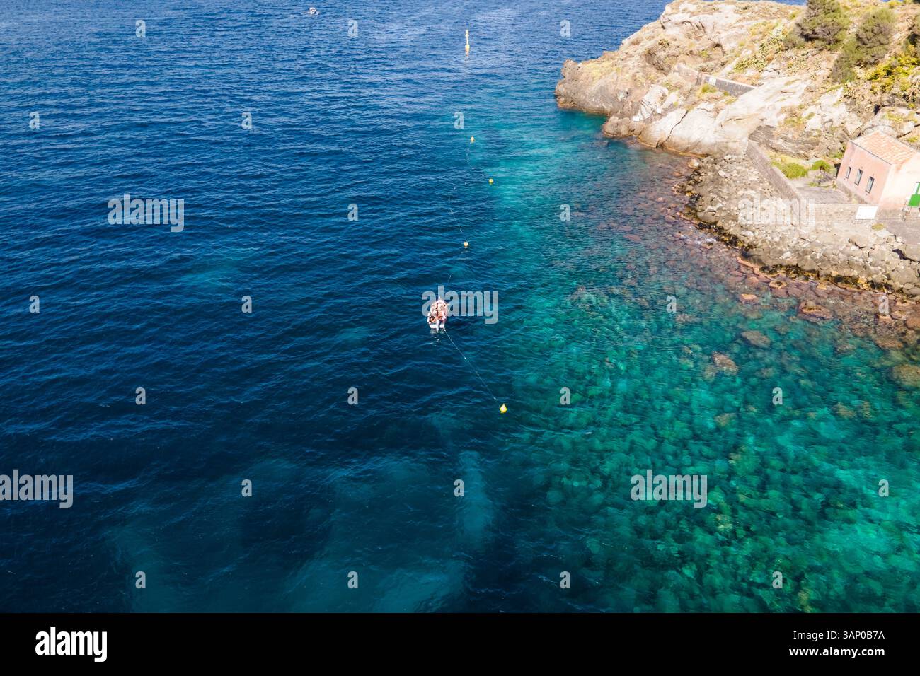 Aerial view of a fishing boat along the coast in Aci Trezza, Sicily ...