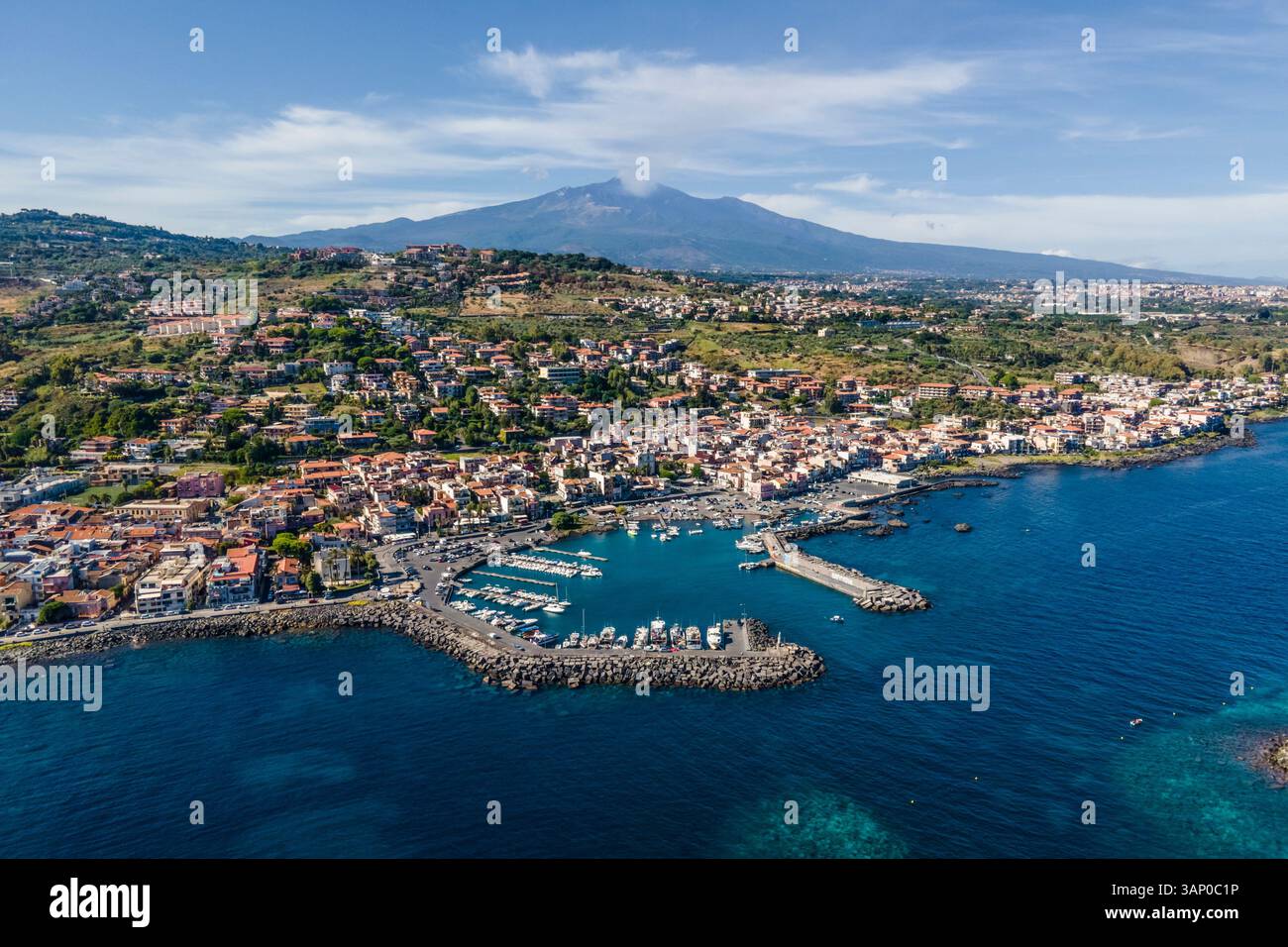 Aerial view of Aci Trezza, a small town along the coast with Etna ...