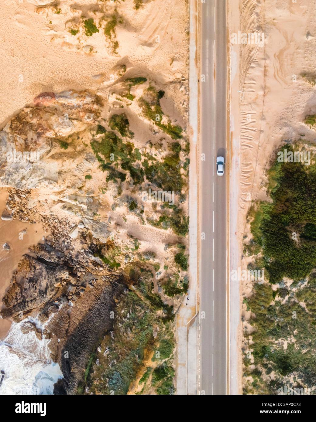 Aerial view of a narrow road with vehicles driving along the wild south ...