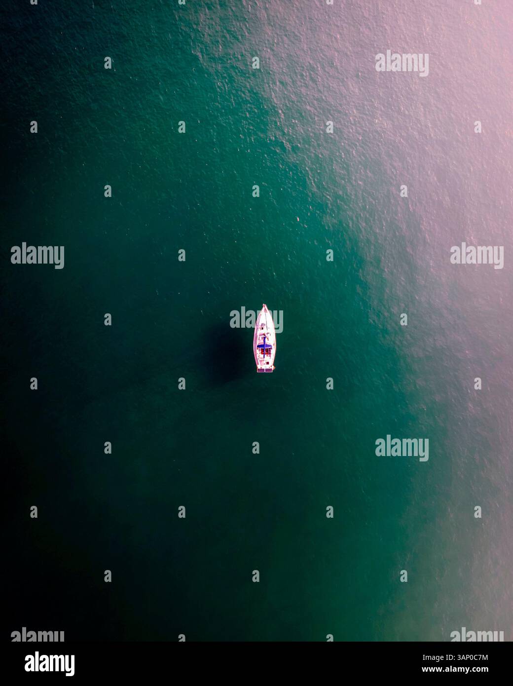 Aerial view of a lone motor boat sailing in the sea near Sagres ...
