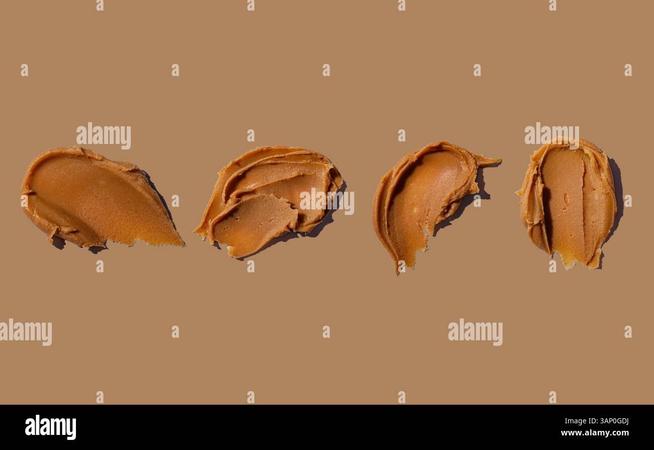 Smear of fresh peanut butter texture background Stock Photo - Alamy