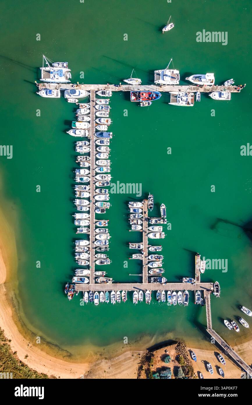 Aerial view of boats anchored at pier at Alvor city port in Ribeira de ...