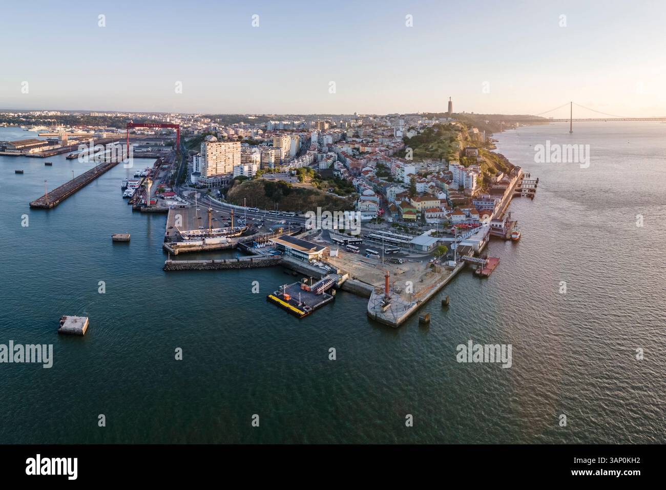 Aerial view of Cacilhas little township along the Tagus river at sunset ...
