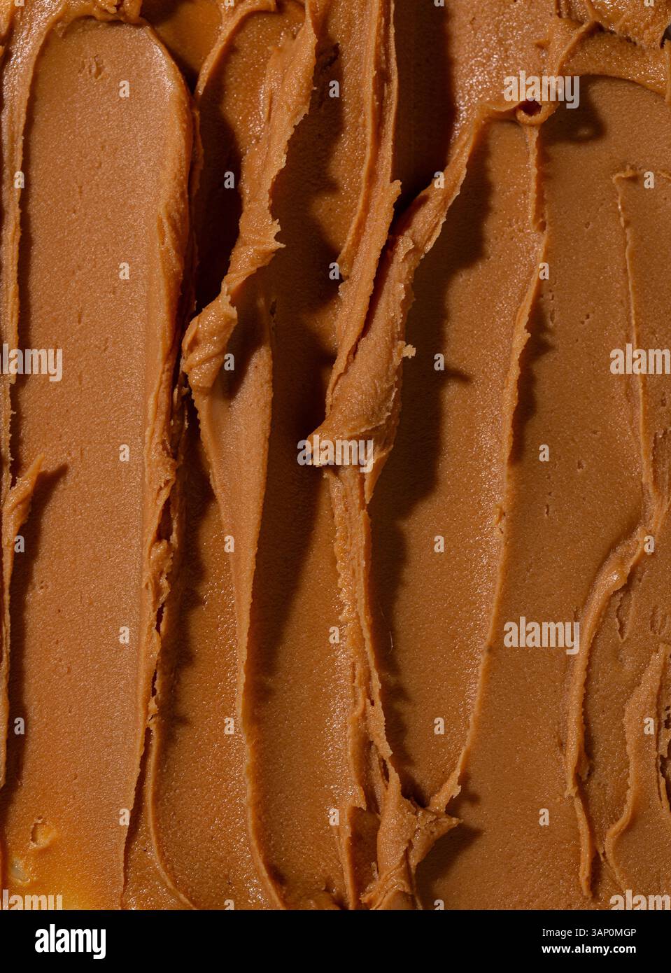 Peanut butter texture background Stock Photo - Alamy