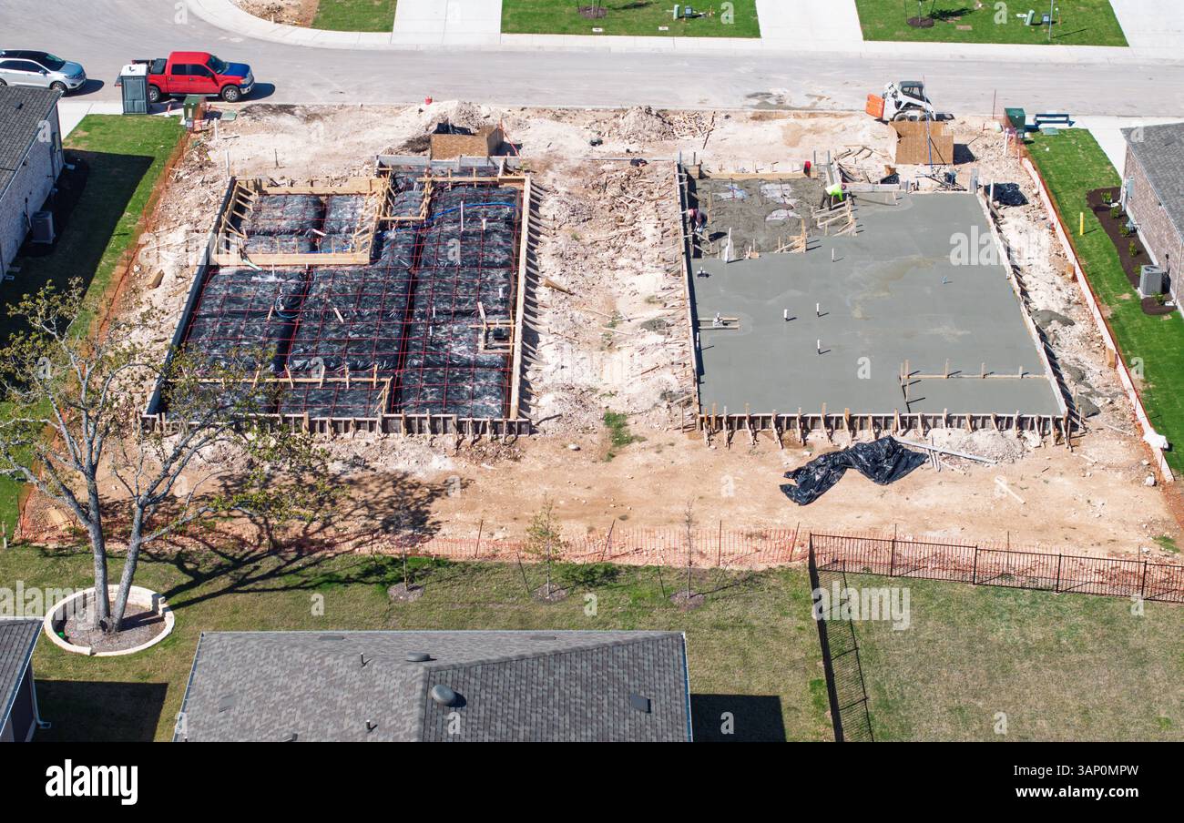 Overhead view of two construction sites, one with a concrete slab and ...