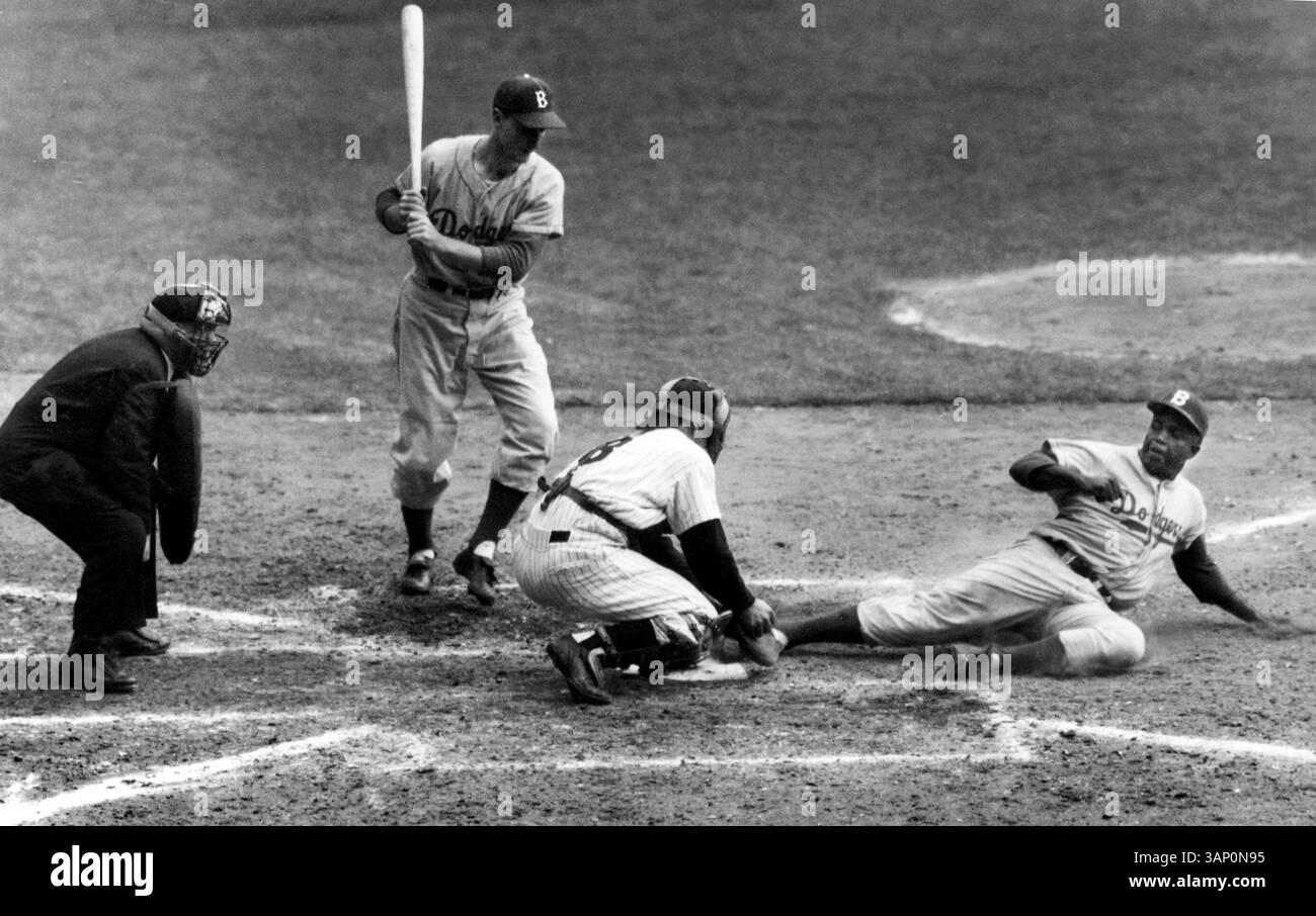 FILE - Brooklyn Dodgers' Jackie Robinson safely steals home plate under ...