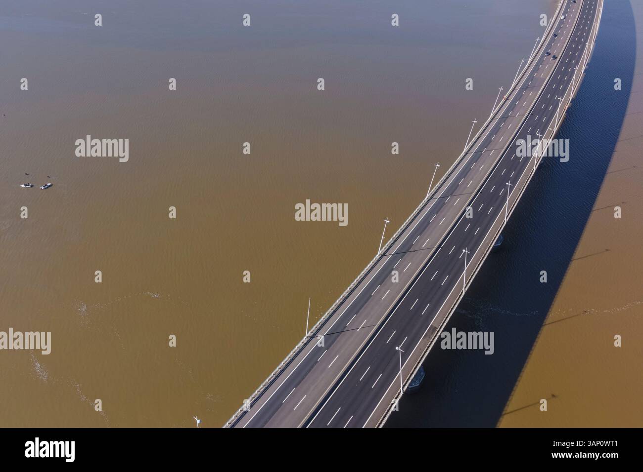 Aerial view of vehicles driving Vasco da Gama suspended bridge crossing ...