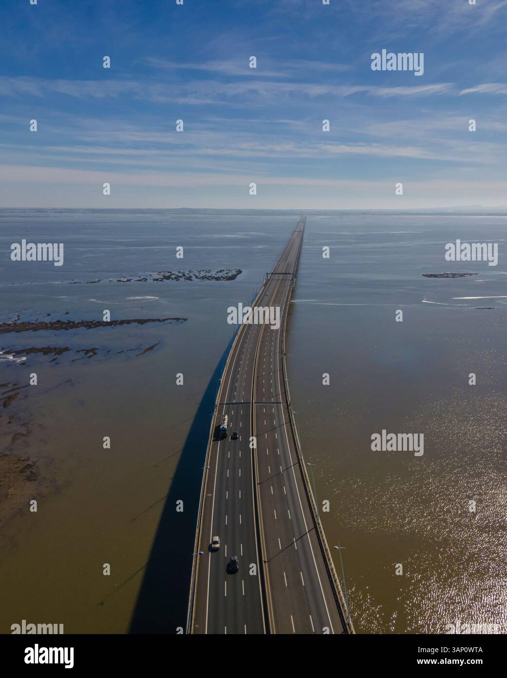 Aerial view of vehicles driving Vasco da Gama suspended bridge crossing ...