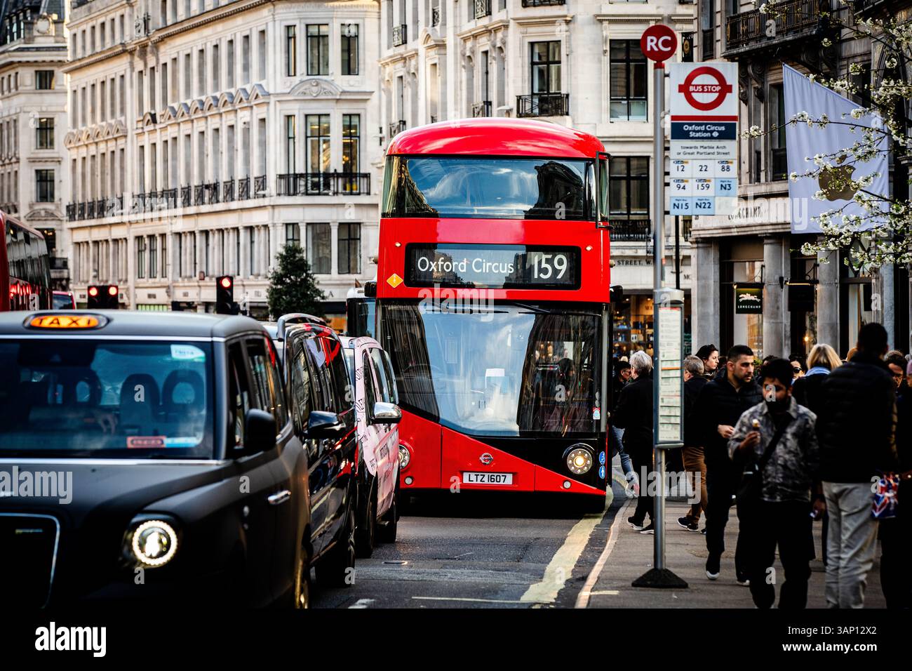 A New Routemaster bus approaching a bus stop for Oxford Circus in ...