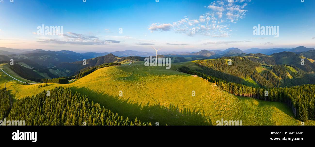 Aerial view of idyllic mountain landscape with wind turbine and scenic ...