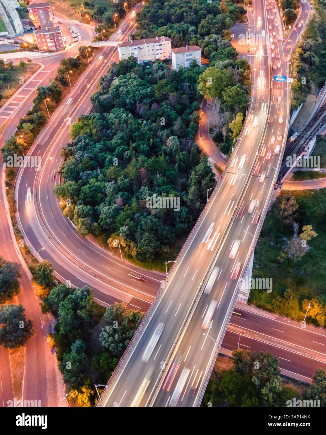 Aerial view of vehicles driving the freeway in Lisbon at sunset ...