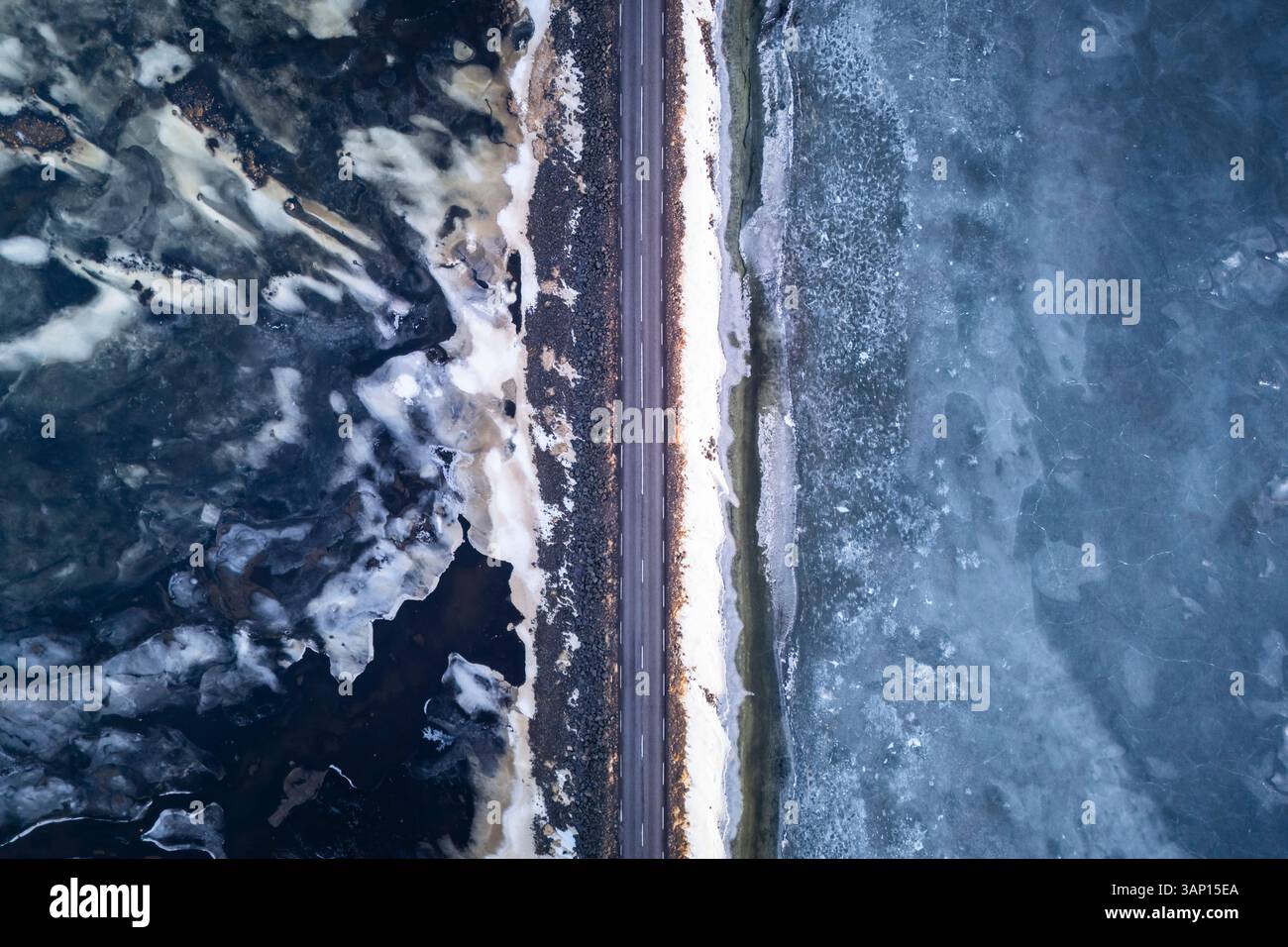 Aerial view of a serene frozen lake and winding road in a beautiful ...