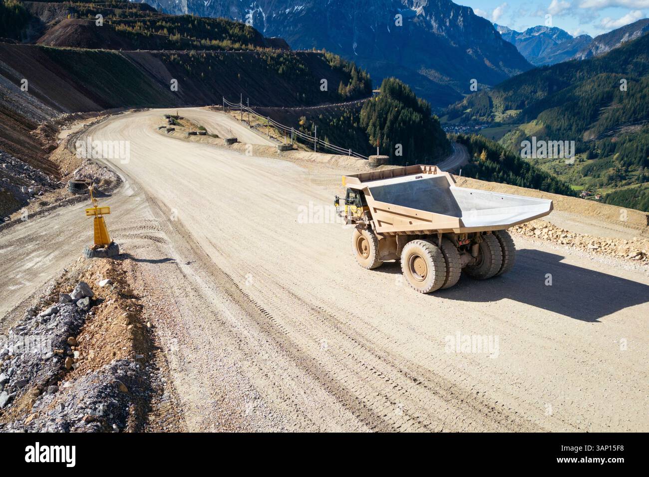 Aerial view of iron ore mine with trucks on dirt road surrounded by ...
