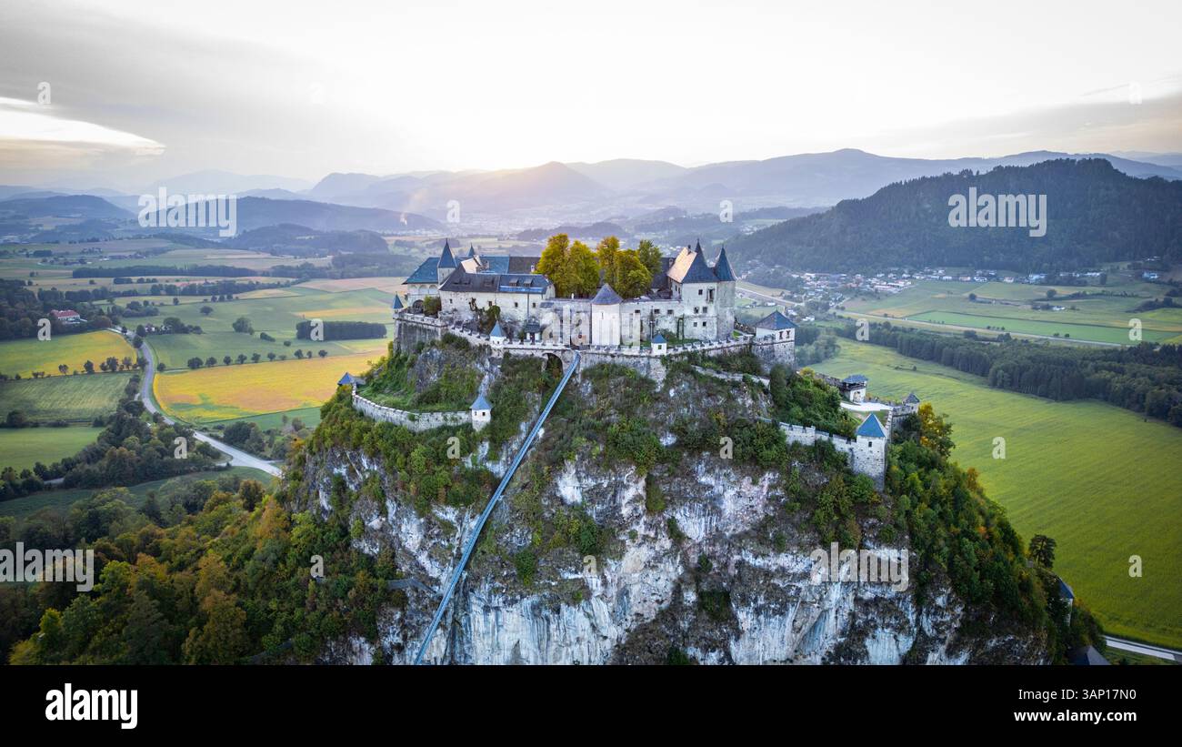 Aerial view of a majestic medieval castle fortress at sunset ...