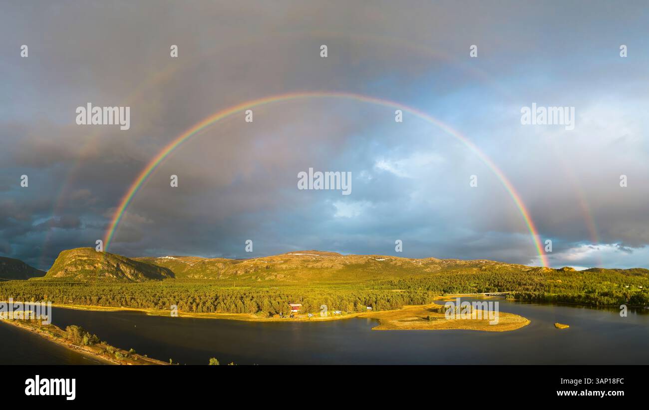 Aerial view of a breathtaking landscape featuring a rainbow over a ...
