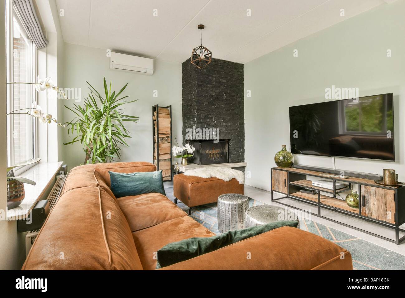 A stylish modern living room featuring a comfortable sofa, minimalist ...