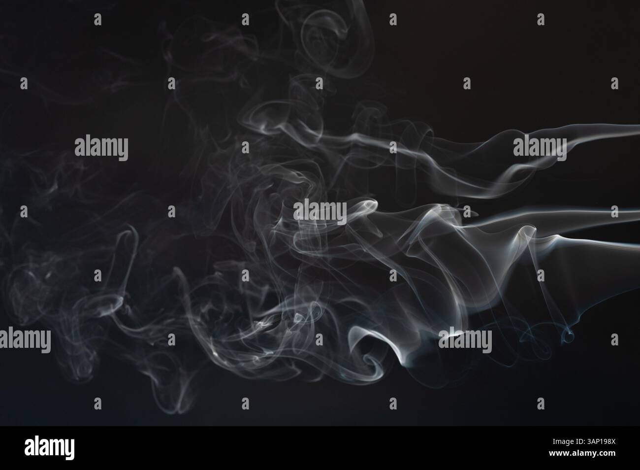 Smoke flow swirls isolated on black studio background Stock Photo - Alamy