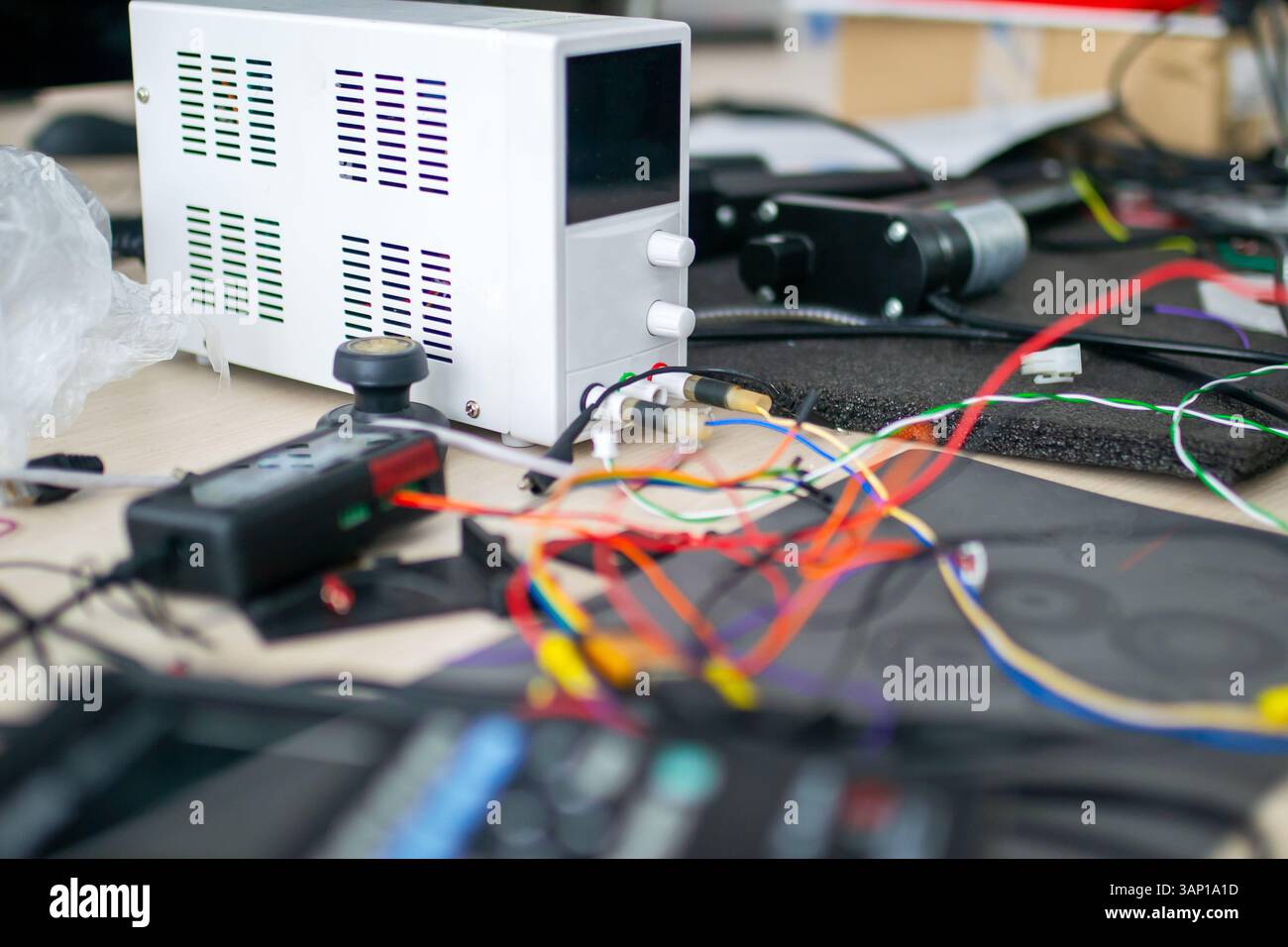 A collection of various wires is connected to a small white box that ...