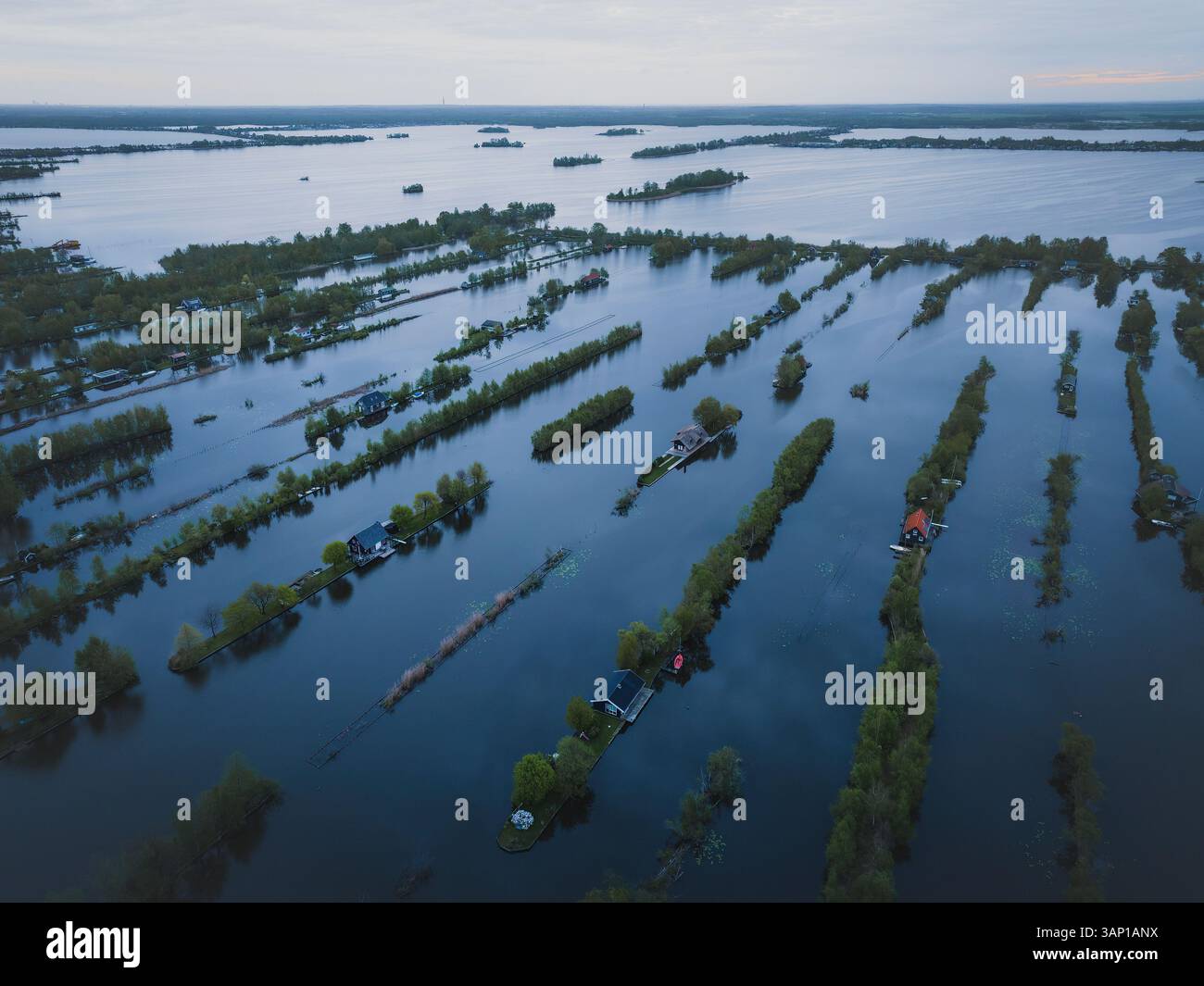 Aerial view of flooded wetland with floating houses and boats ...