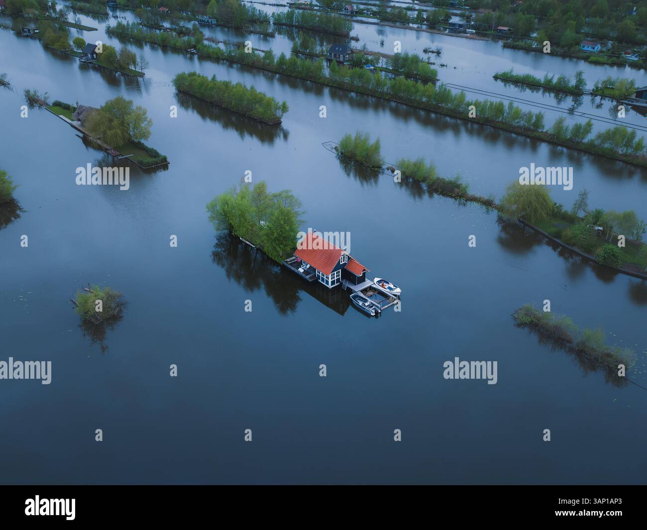 Aerial view of flooded Scheendijk with floating houses and boats ...
