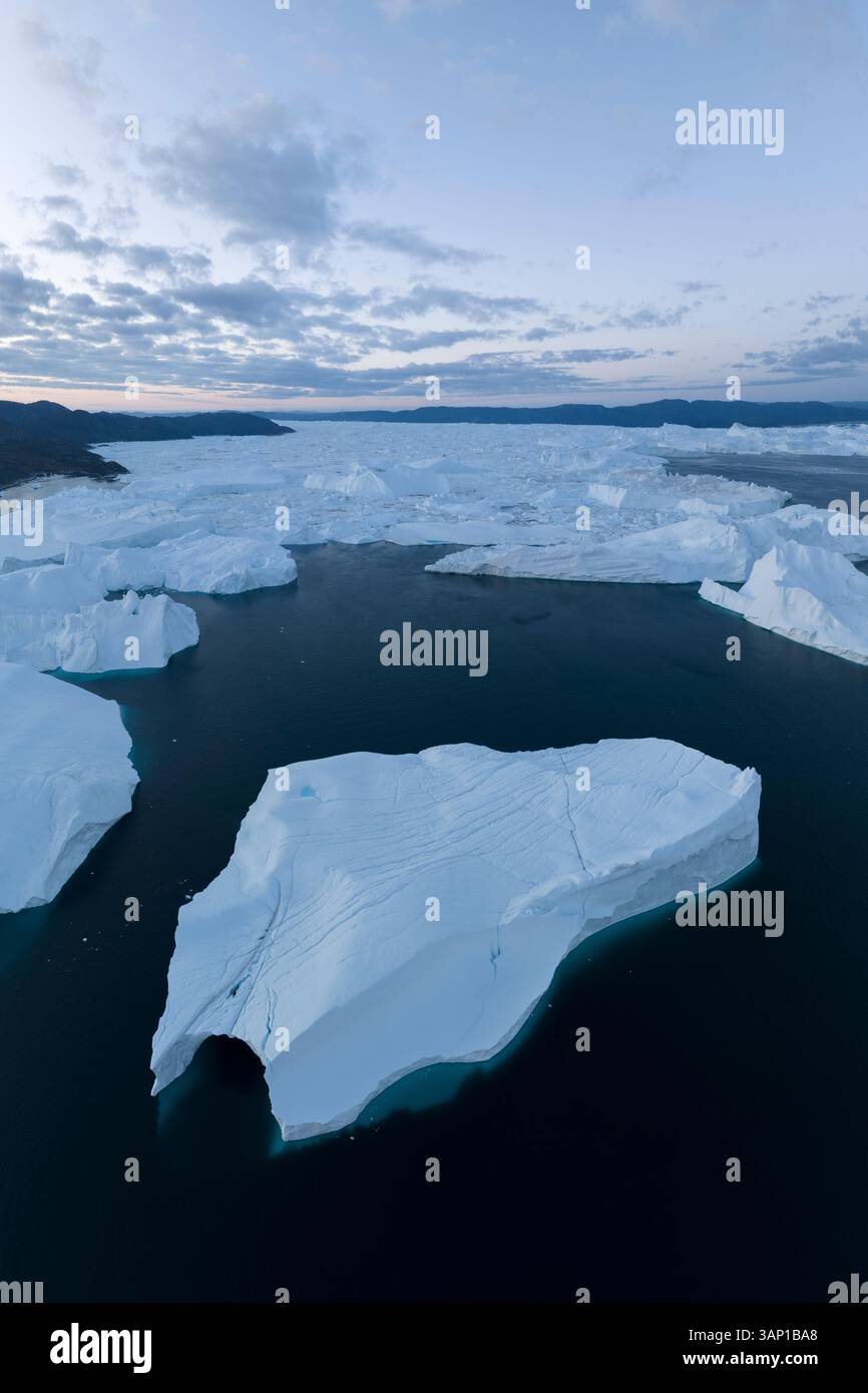 Aerial drone view huge iceberg with a cave at the Ilulissat ice fjord ...