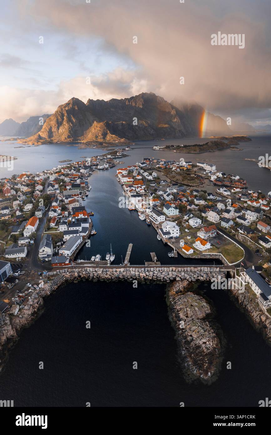 Aerial drone view of an rainbow over a nordic sea village in the ...