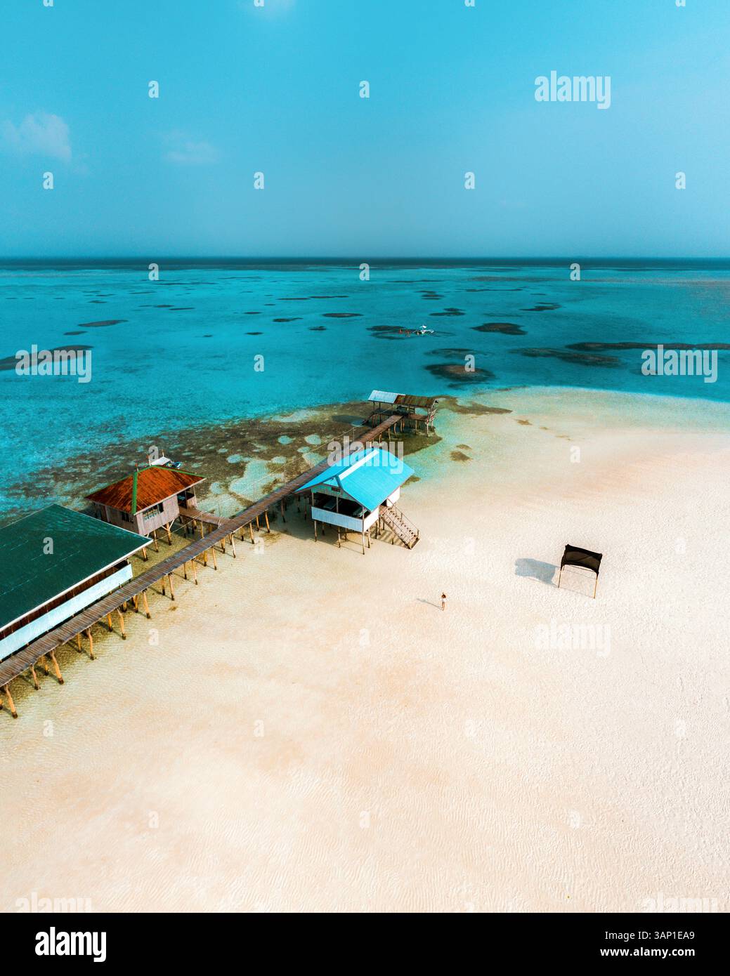 Aerial view of a woman walking on sandbar near the pier at Balabac ...