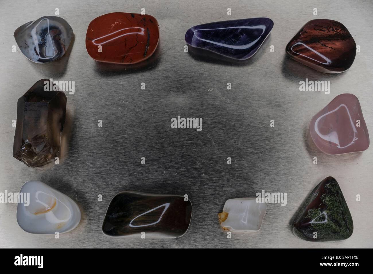 Gemstones frame with silver background Stock Photo - Alamy